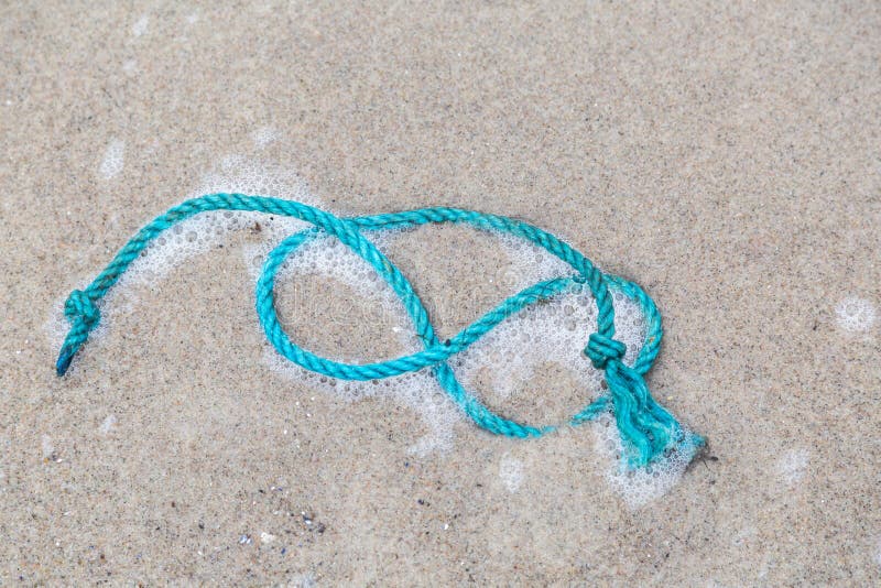 A Piece of Rope Lies on a Beach Stock Photo - Image of surface, summer ...