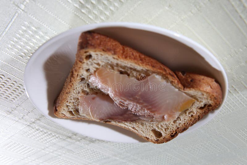 Piece of Bread and Salted Fish on a White Saucer Stock Photo - Image of ...
