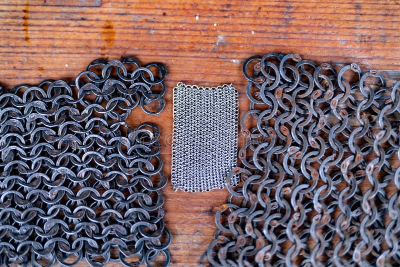 A Piece of Chain Mail is Shown with a Silver Piece of Metal in the ...