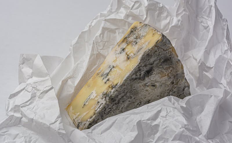 Piece of Cheese with Mold on White Crumpled Paper Close-up Stock Image ...