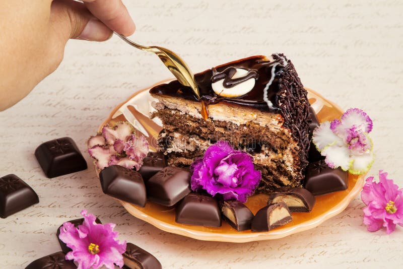 A Piece of Chocolate Cake with Violets. Which Break Off Stock Image ...