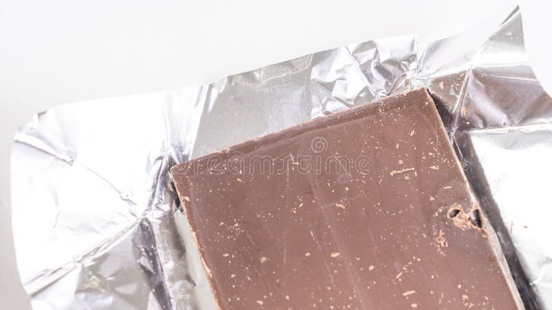 A Piece of Chocolate is Sitting on Top of a Foil Wrapper Stock Photo ...