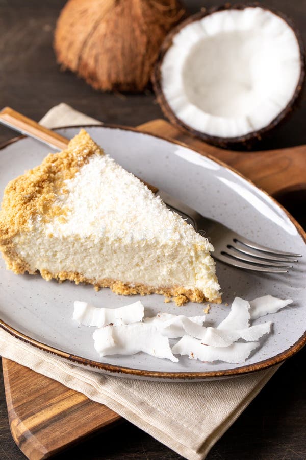 Piece of Coconut Cheesecake on a Plate with Fresh Coconut Stock Photo ...