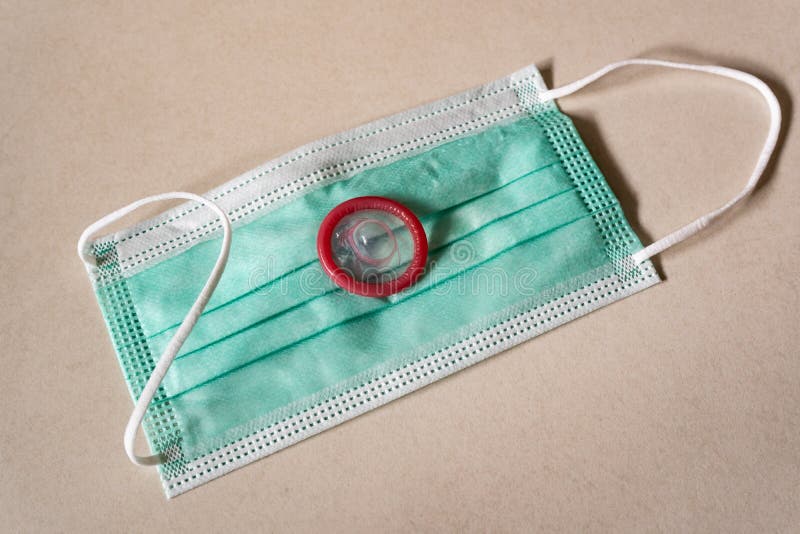 A Piece of Condom and Face Mask Stock Photo - Image of covid ...