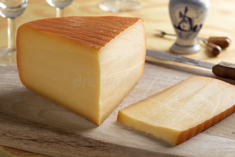 Piece of Dutch Kernhem Cheese and a Slice on a Cutting Board Stock ...