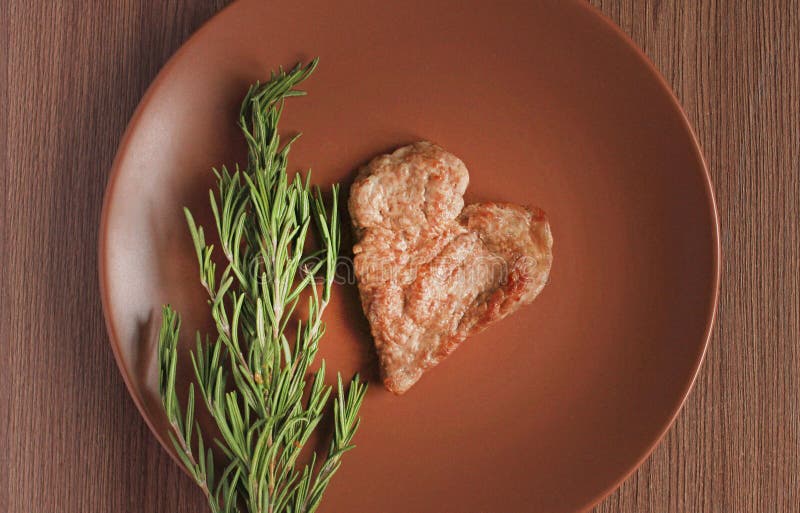A Piece of Fried Pork Meat in the Shape of a Heart on a Plate Stock ...