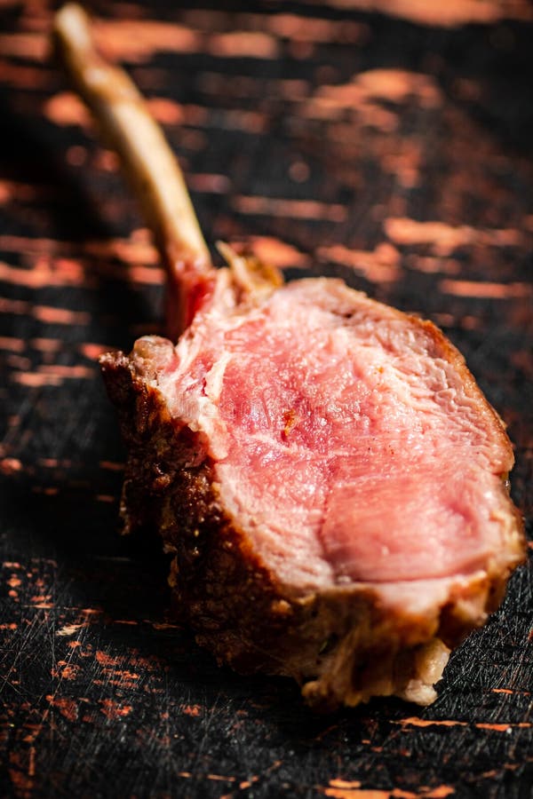 A Piece of Grilled Rack Lamb on the Table. Stock Photo - Image of ...