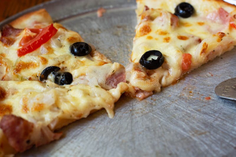 A Piece of Hot Pizza on a Metal Mold. Leftover Pizza Stock Photo ...