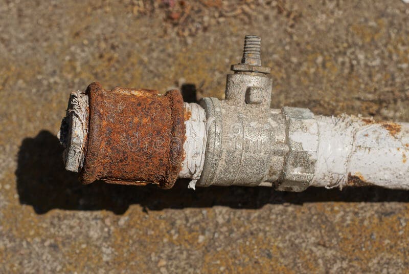 A Piece of an Old Gray Metal Pipe with a Broken Faucet and a Rusty ...