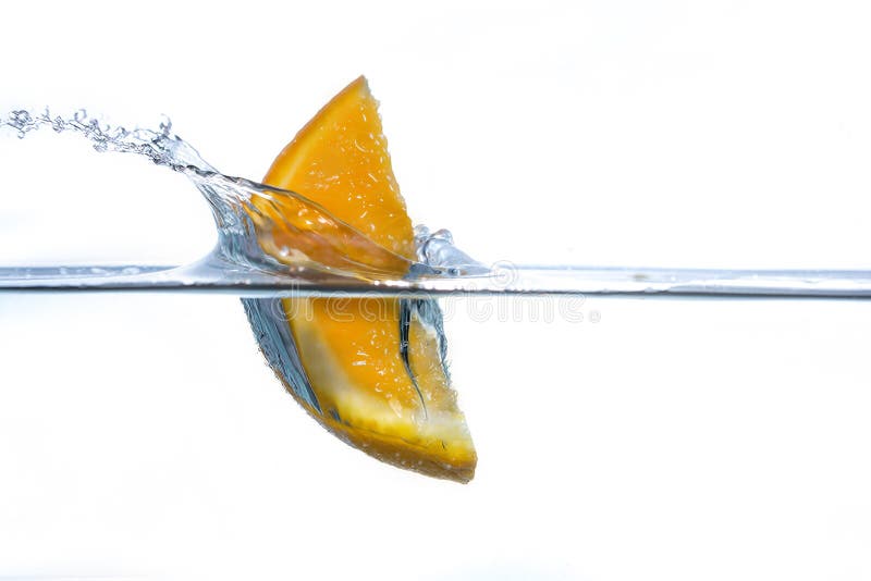 Piece on an Orange Falling into Water with a Splash Stock Image - Image ...