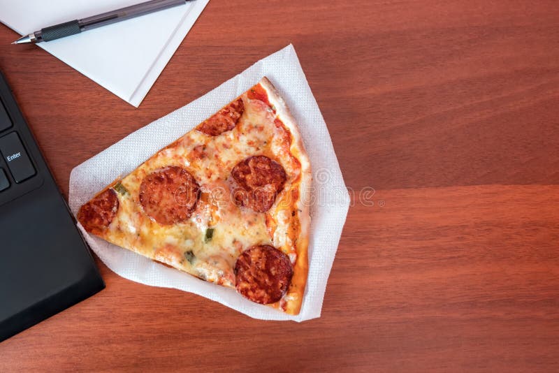 A Piece of Pizza on the Desktop. Lunch Break in the Office Stock Photo ...