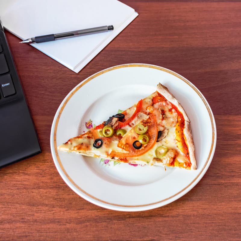 A Piece of Pizza on the Desktop. Lunch Break in the Office Stock Photo ...
