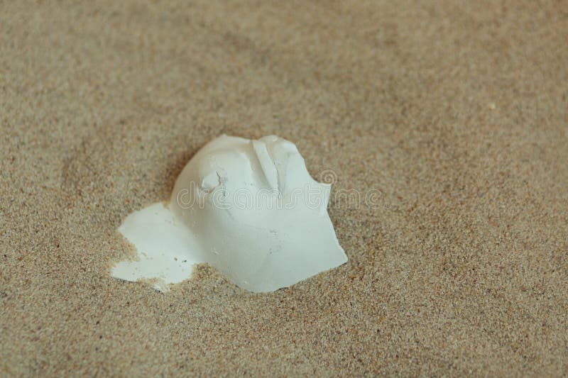 A Piece of Plaster Face Sculpture in the Sand. Stock Photo - Image of ...
