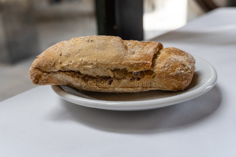 Piece of Rustic Bread on a Plate on a Bench Tablecloth Stock Photo ...