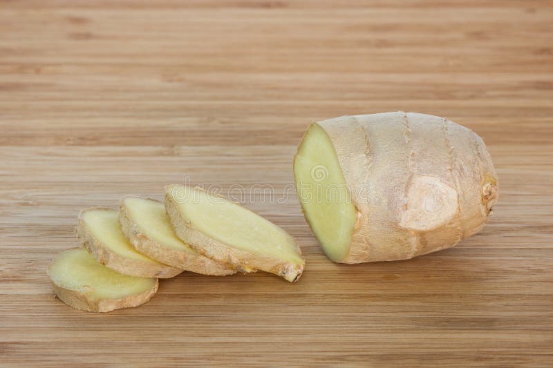 Piece and Slices of Ginger Root on Chopping Board Stock Image - Image ...