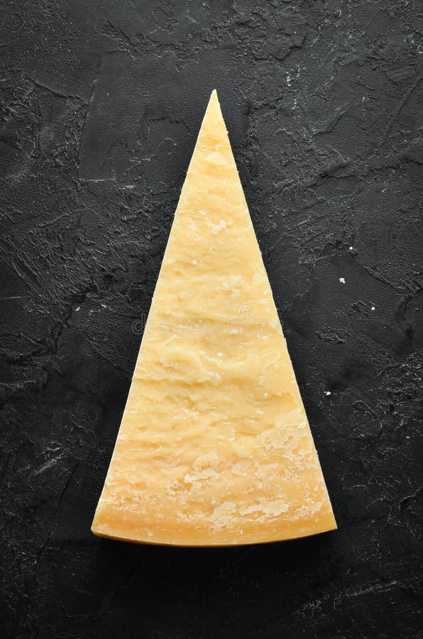 Piece of Solid Cheese on a Black Stone Background. Parmesan. Top View ...