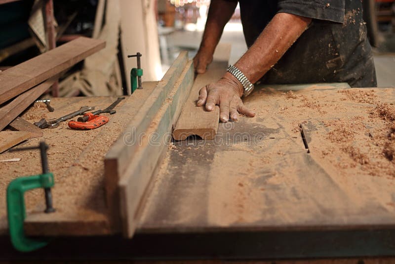 Piece of Wooden Board is Being Shaved on a Router Table by Hands of ...