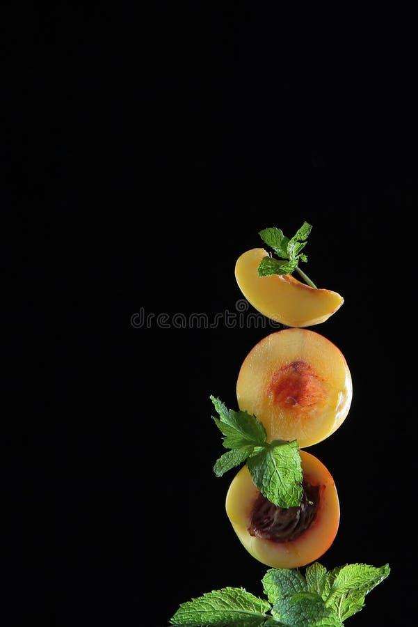 Pieces of Apricot and Mint on a Black Background. Fresh Apricot Cut in ...