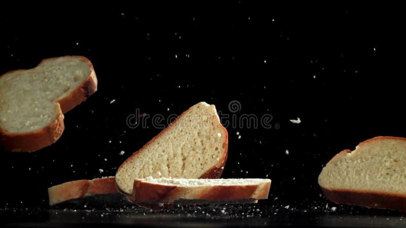 Pieces of Bread Falling on a Black Background. Filmed on a High-speed ...