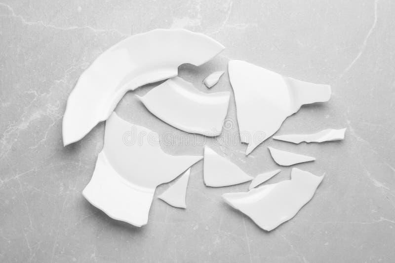 Pieces of Broken Ceramic Plate on Light Grey Table, Flat Lay Stock ...