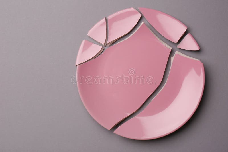 Pieces of Broken Pink Ceramic Plate on Grey Background, Top View. Space ...