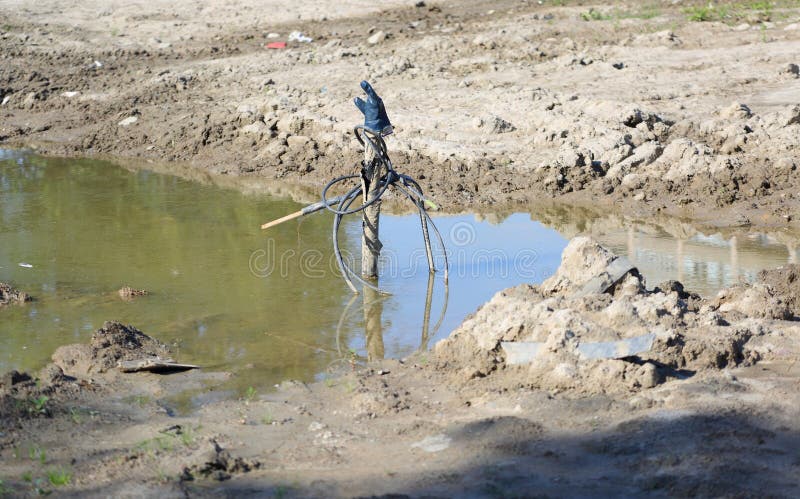 Pieces of Cable are Wound on a Stake Driven into the Bottom of a Deep ...