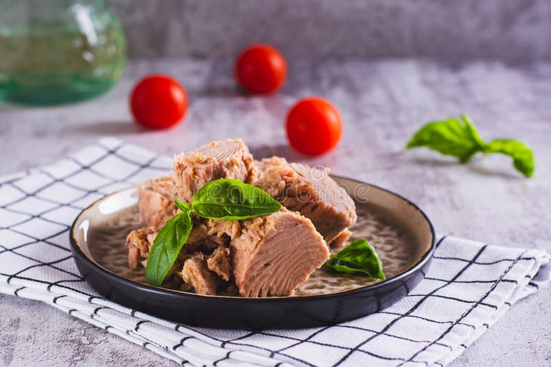 Pieces of Canned Tuna and Basil Leaves on a Plate Stock Image - Image ...