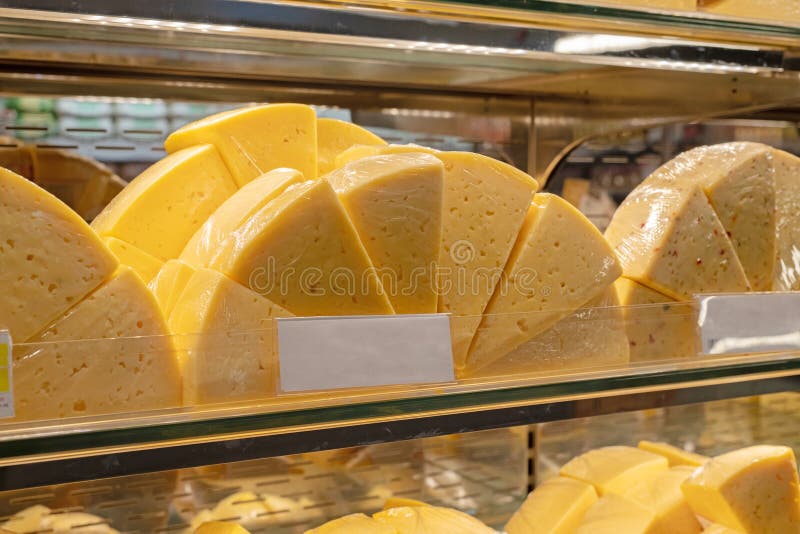 A Pieces of Cheese in the Shop Window Stock Photo - Image of heads ...