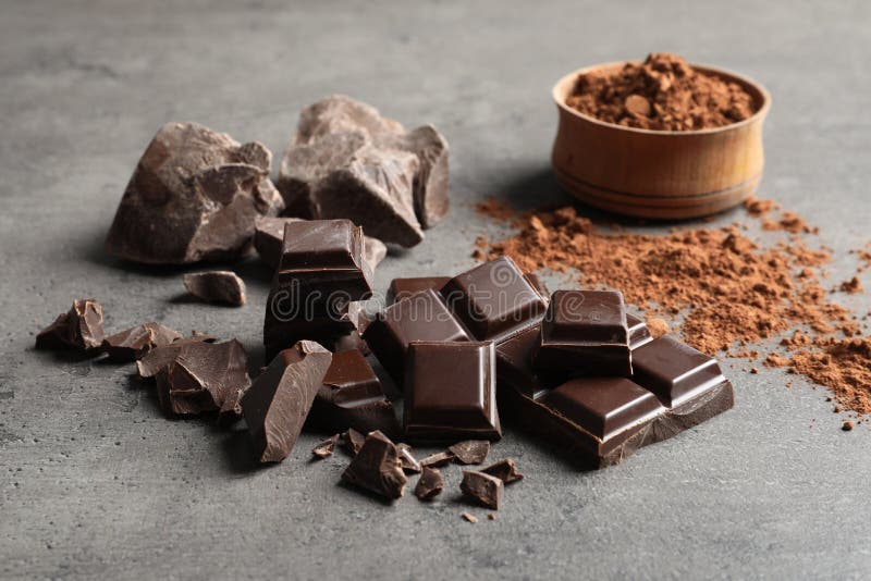 Pieces of Chocolate and Cocoa Powder on Grey Stock Image - Image of ...