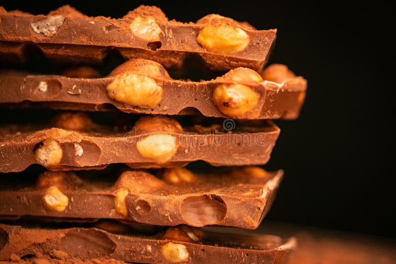 Pieces of Chocolate with Nuts Stack on a Black Background.Broken ...