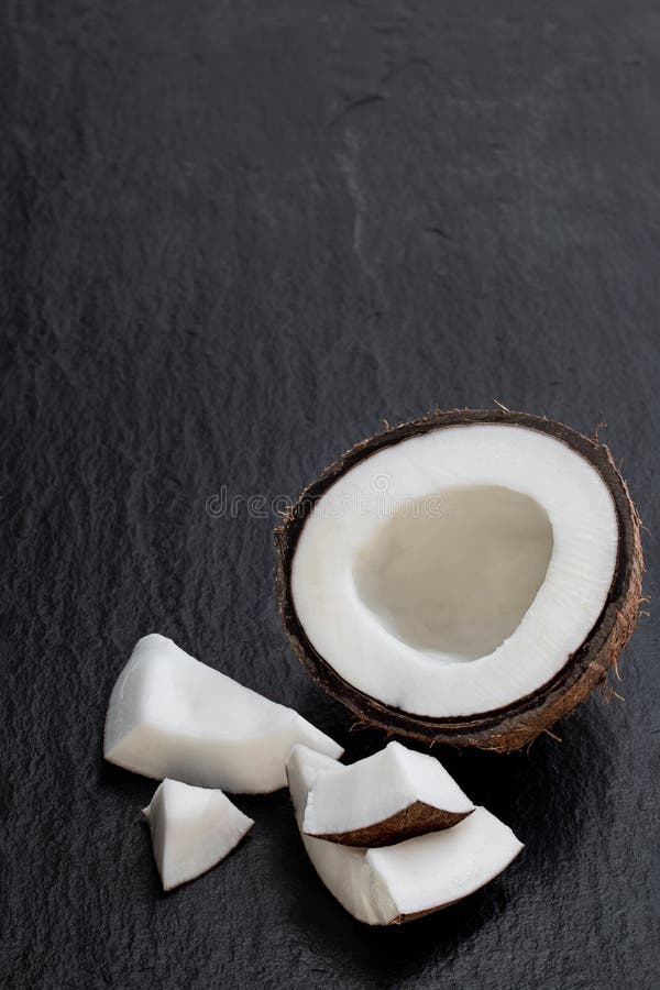 Pieces of Coconut on Black Stone Background Stock Photo - Image of ...