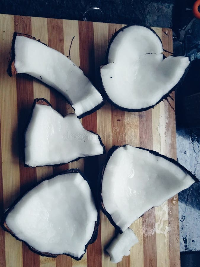 Pieces of Coconut in Shell on a Cutting Board Stock Image - Image of ...