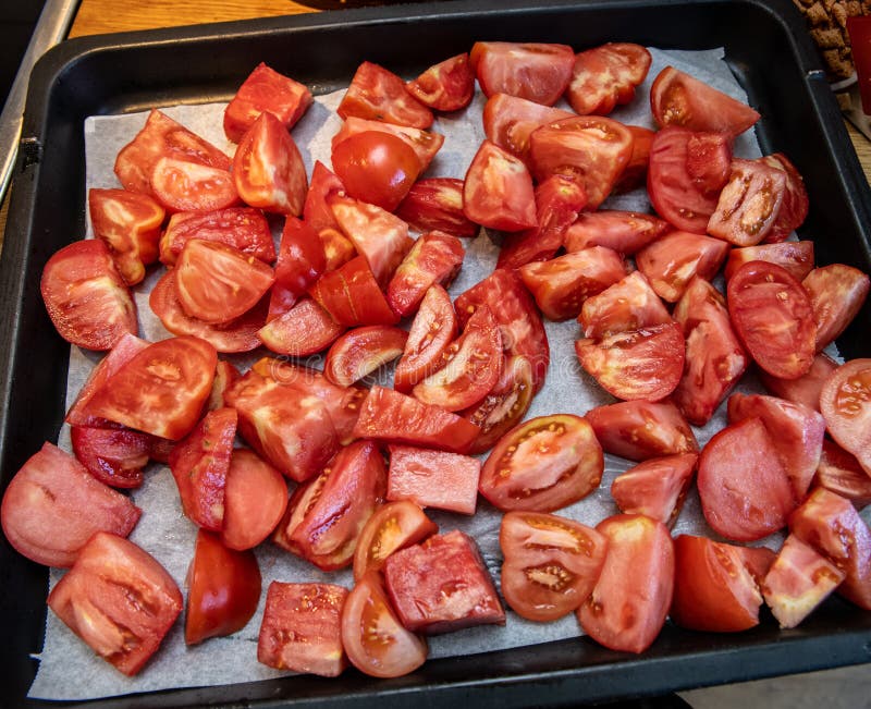 Pieces of Cut Up Tomatoes on a Stove Plate.. Stock Photo - Image of ...