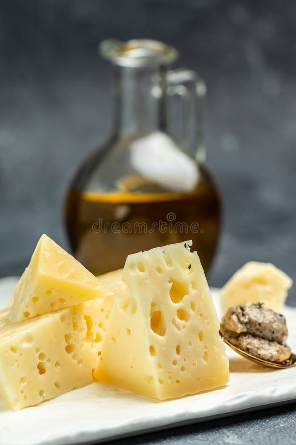 Pieces of Delicious Cheese with Holes and Truffle Paste. Vertical Image ...