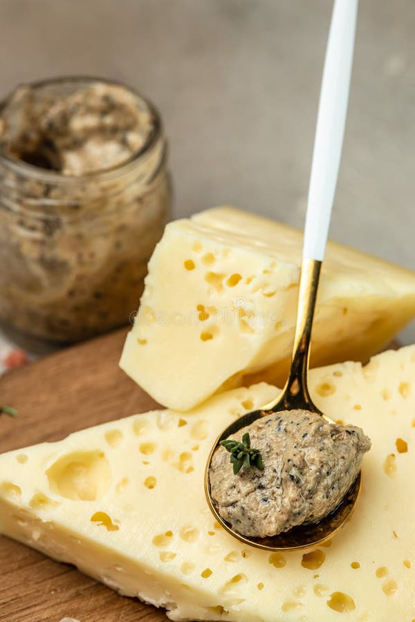 Pieces of Delicious Cheese with Holes and Truffle Paste. Vertical Image ...