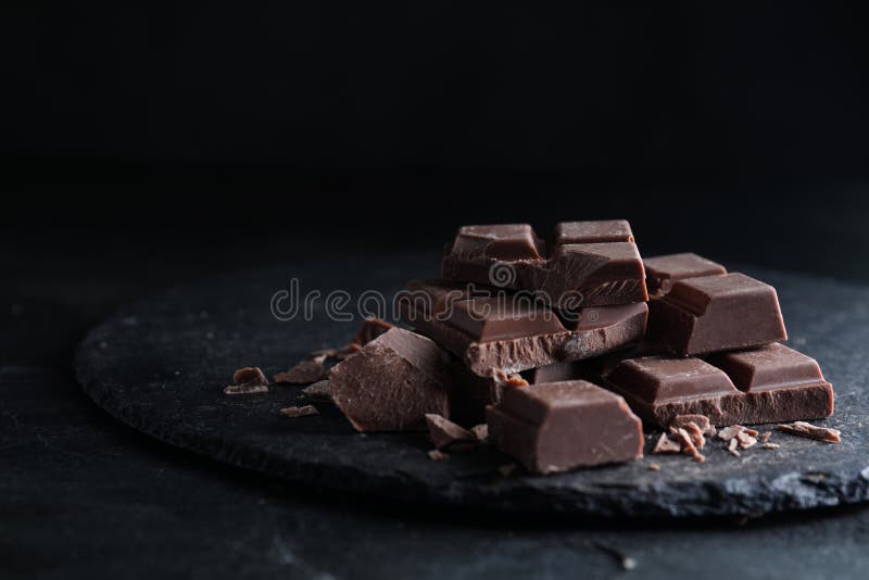 Pieces of Delicious Natural Milk Chocolate on Plate Stock Photo - Image ...