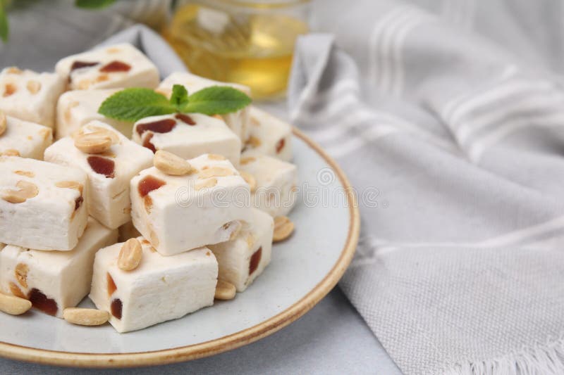 Pieces of Delicious Nutty Nougat on Light Table, Closeup Stock Photo ...