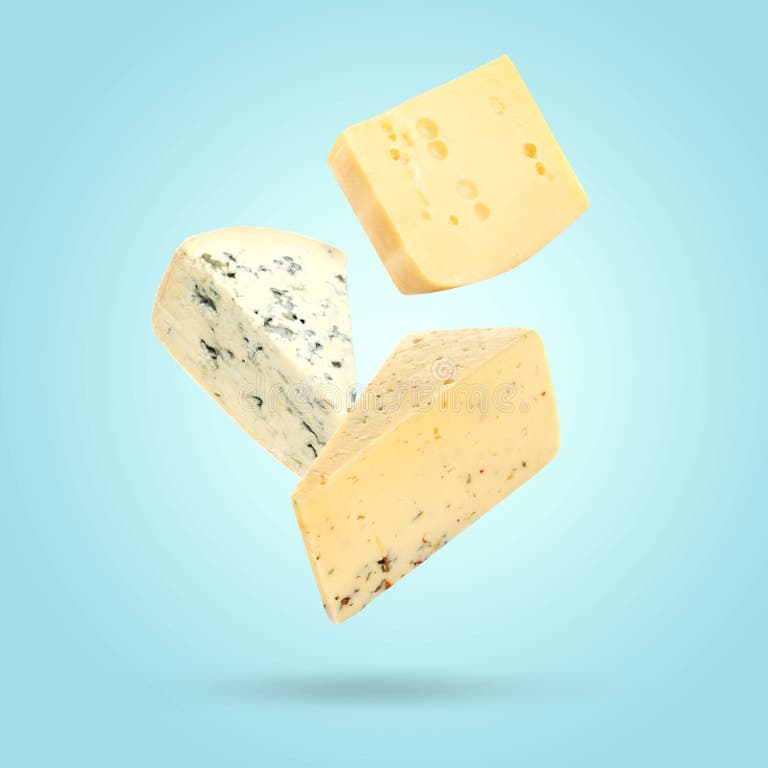 Pieces of Different Delicious Cheese Falling on Light Blue Background ...