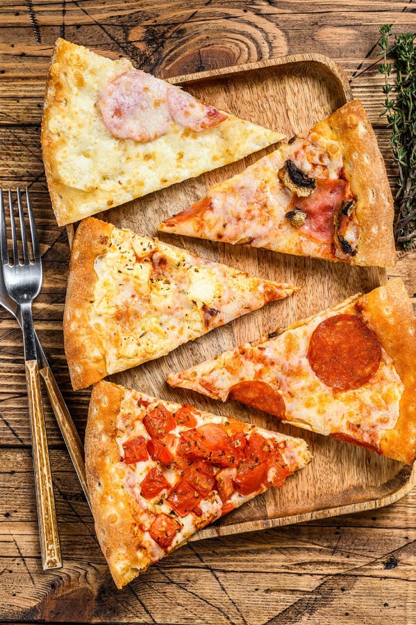 Pieces of Different Pizza Various Types. Wooden Background Stock Image ...