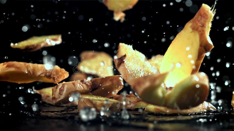 Pieces of Fresh Ginger Fall on the Table. Filmed on a High-speed Camera ...