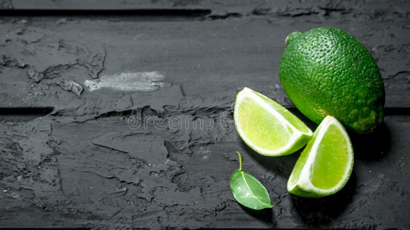 Pieces of Fresh Lime and One Whole Lime Stock Image - Image of citrus ...
