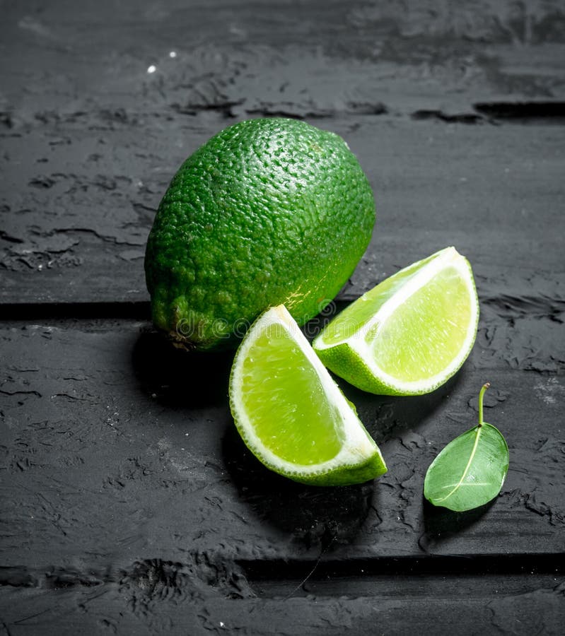 Pieces of Fresh Lime and One Whole Lime Stock Photo - Image of element ...