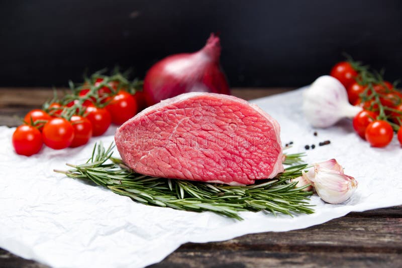 A Pieces of Fresh Meat, Beef Slab, Decorated with Greens and Vegetables ...