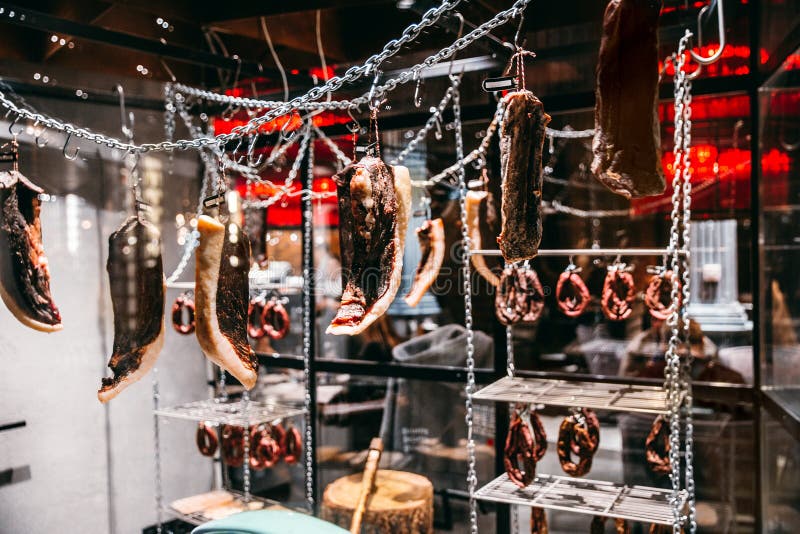 Pieces of Fresh Raw Lamb Hanging on Hooks in Refrigerator Stock Photo ...