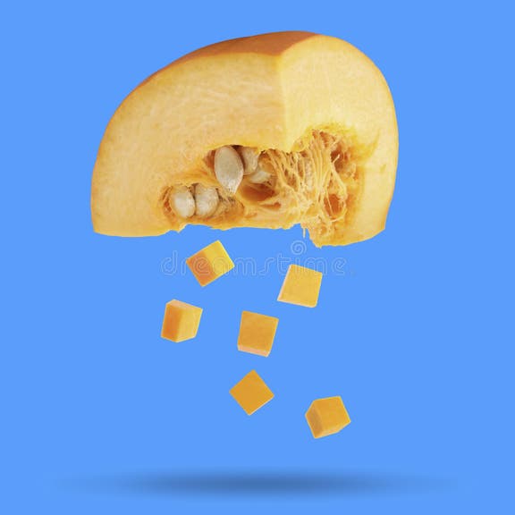 Pieces of Fresh Raw Pumpkin Falling on Blue Background Stock Image ...