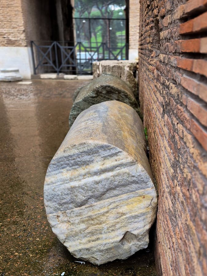 Pieces of Granite Pillars Leaning Against a Rustic Wall Inside the ...