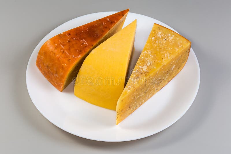 Pieces of Hard Cheese on Dish on a Gray Background Stock Photo - Image ...
