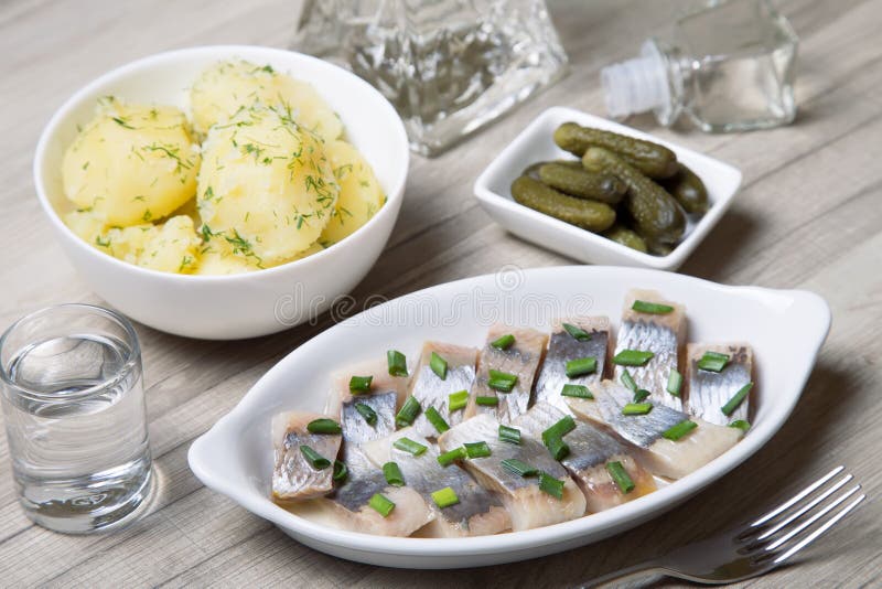 Pieces of Herring with Onions, Gherkins, Boiled Potatoes and Vodka ...
