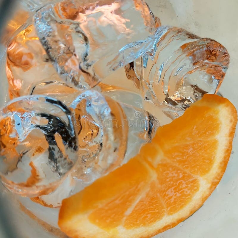 Pieces of Ice with an Orange Slice in a Transparent Container Stock ...