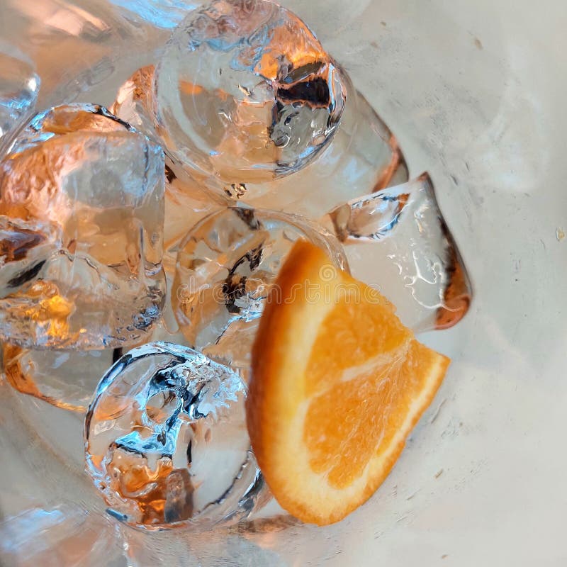 Pieces of Ice with an Orange Slice in a Transparent Glass Stock Photo ...